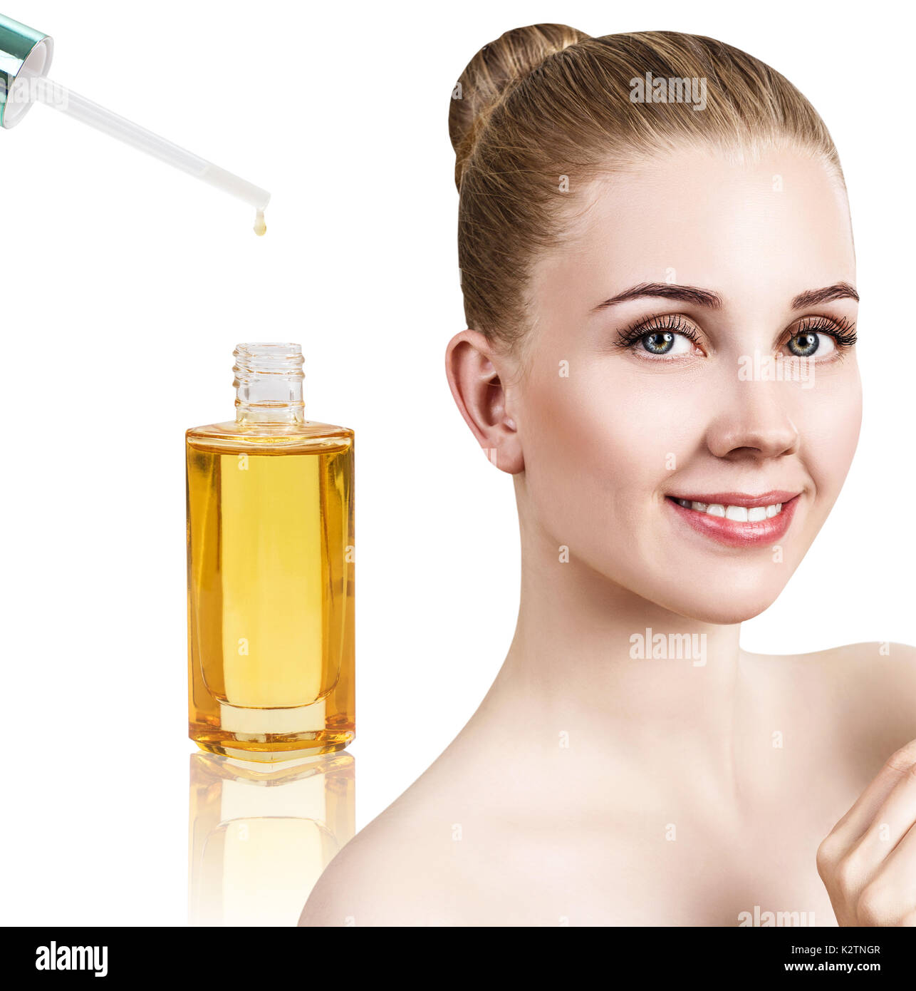 Cosmetic oil applying on face of young woman Stock Photo - Alamy