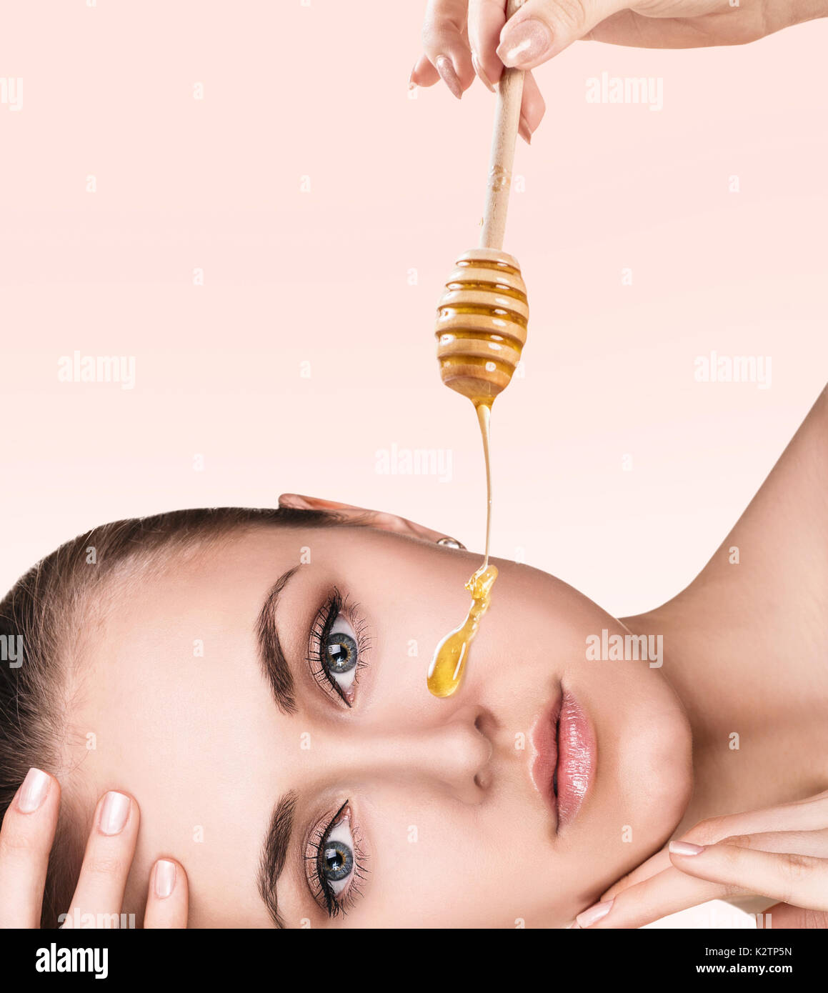 Beautiful woman with honey on face Stock Photo - Alamy