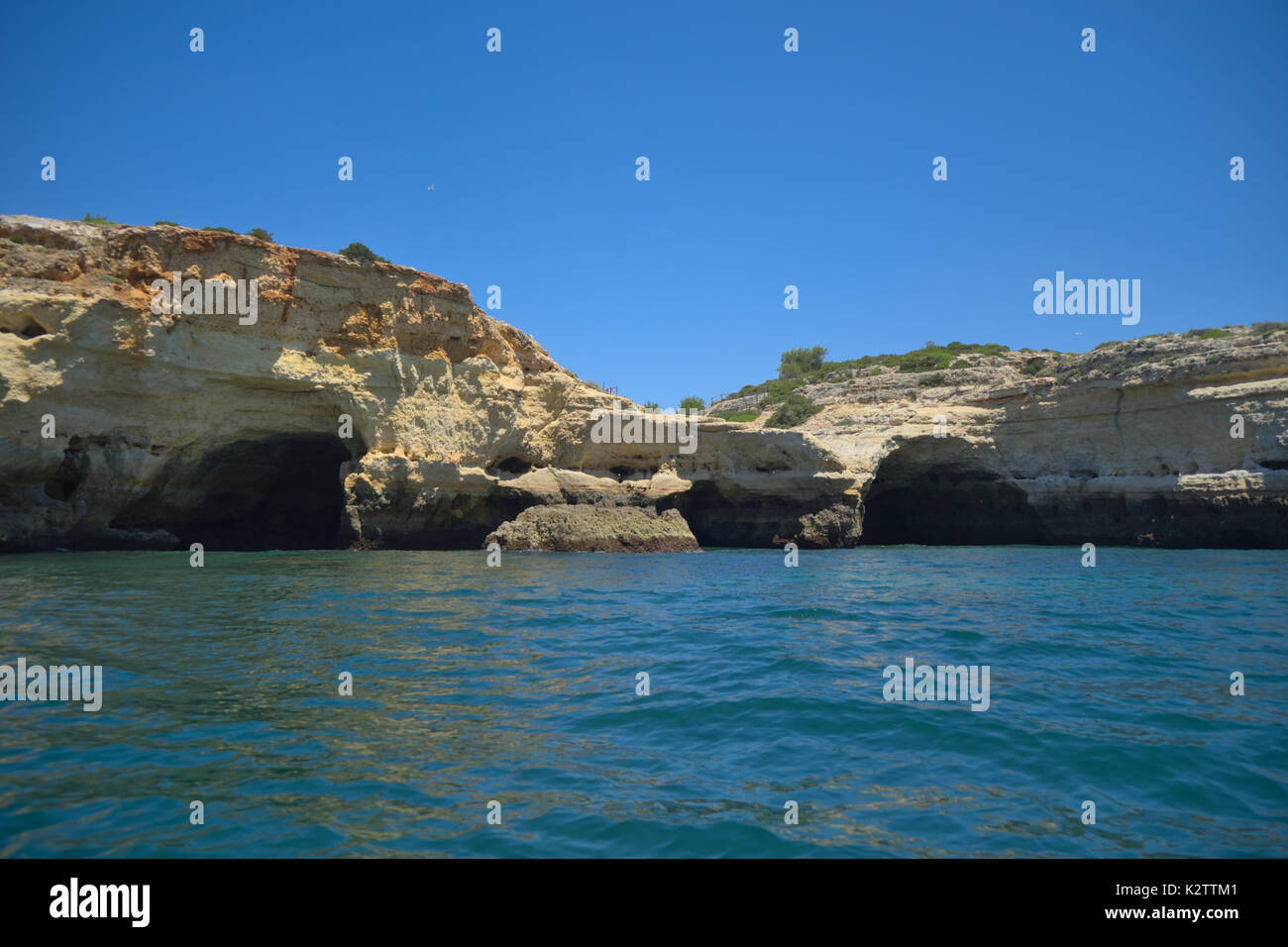 Caves along algarve atlantic ocean coast in cliffs hi-res stock ...