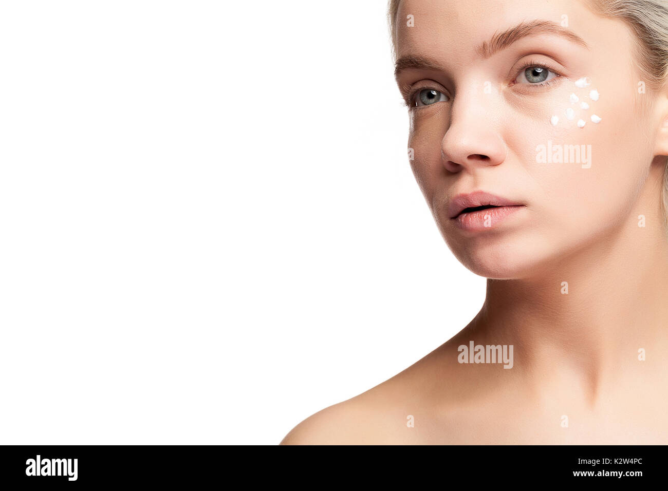 Portrait of Gorgeous beautiful woman with cream face drops on her face ...