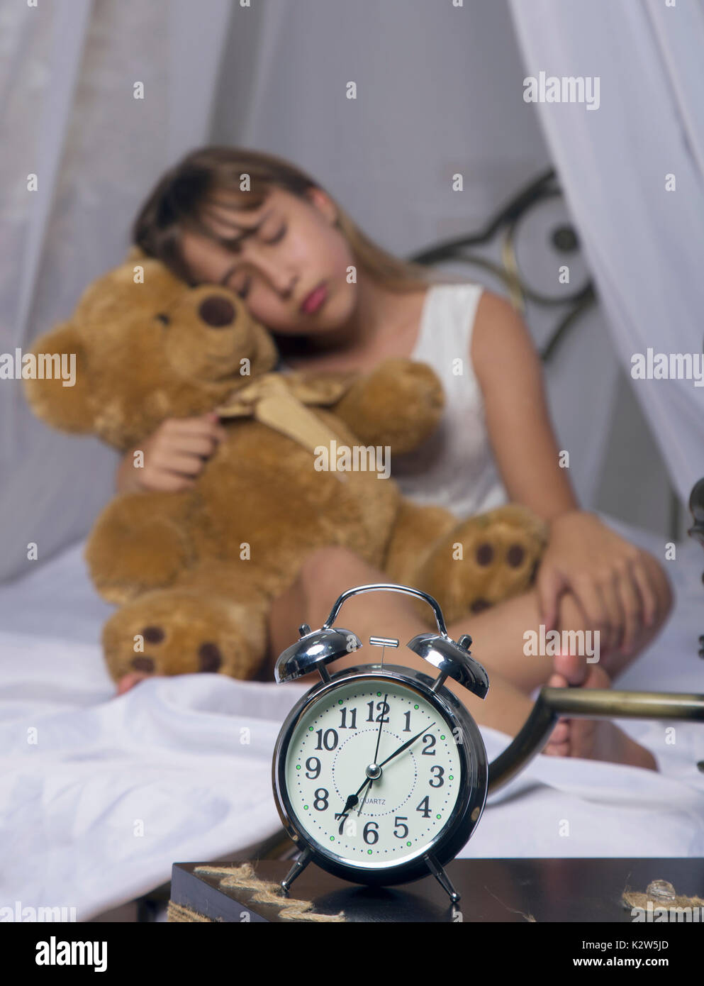 Early awakening. Alarm clock standing on bedside table. Wake up of an ...