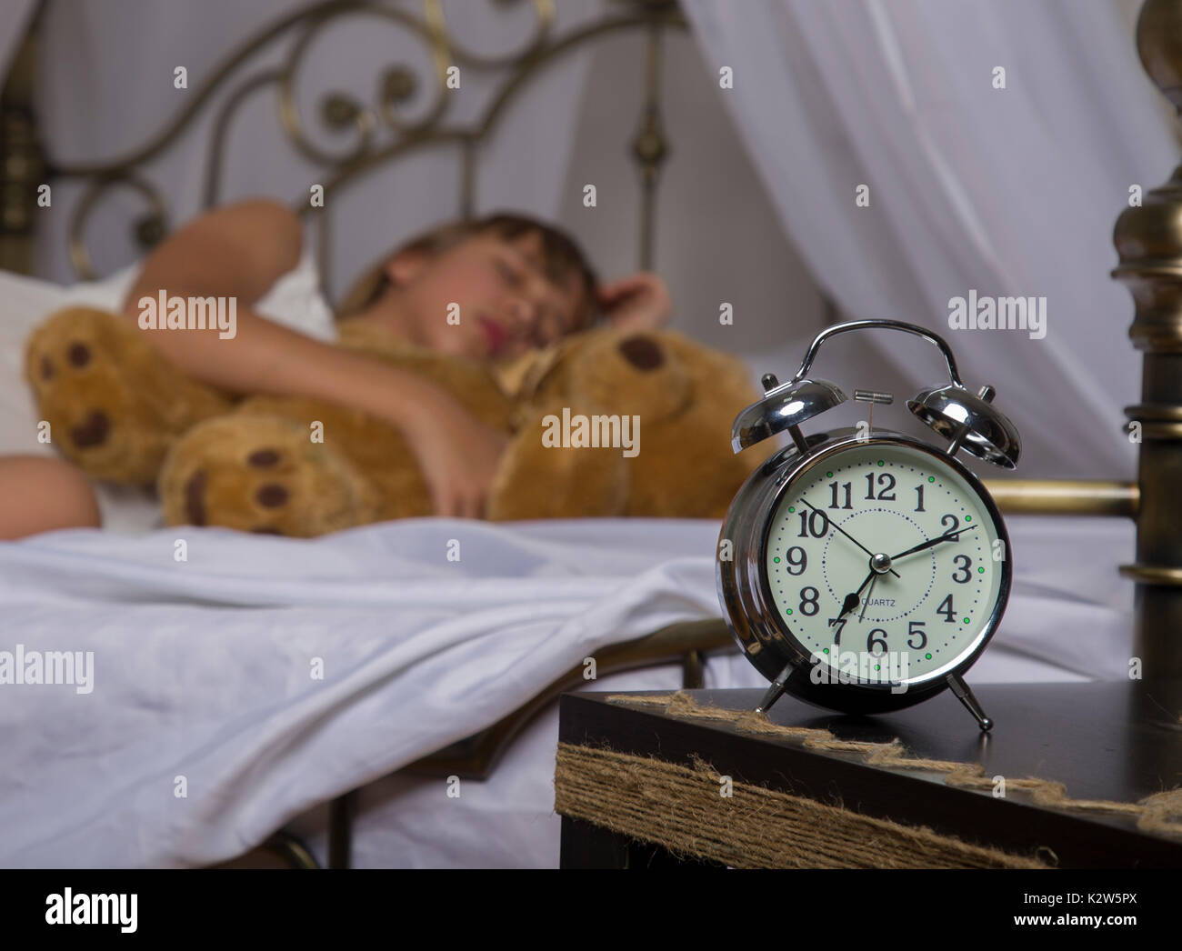 Early awakening. Alarm clock standing on bedside table. Wake up of an ...