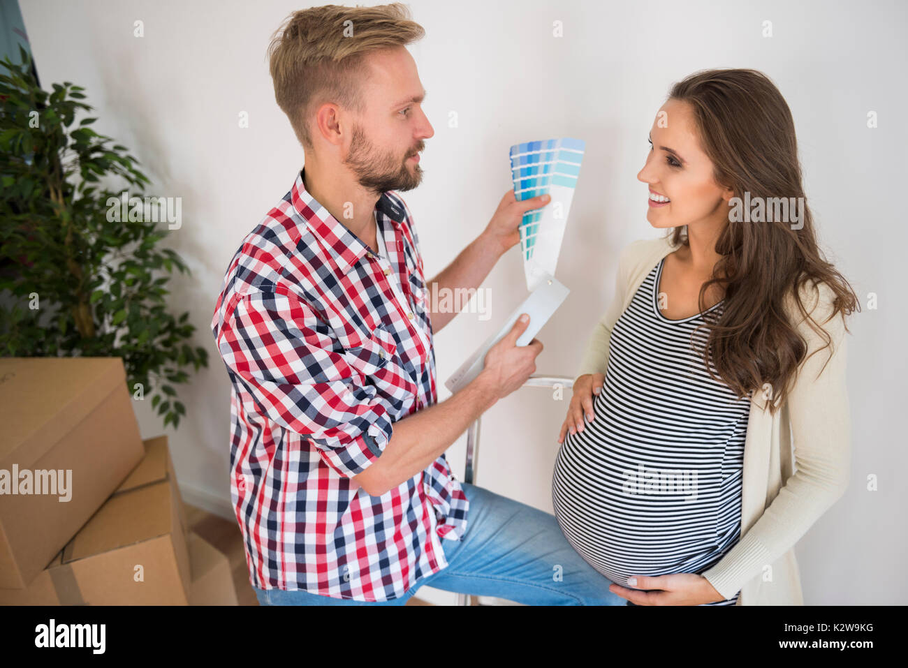 Young couple making decision about the new color Stock Photo - Alamy