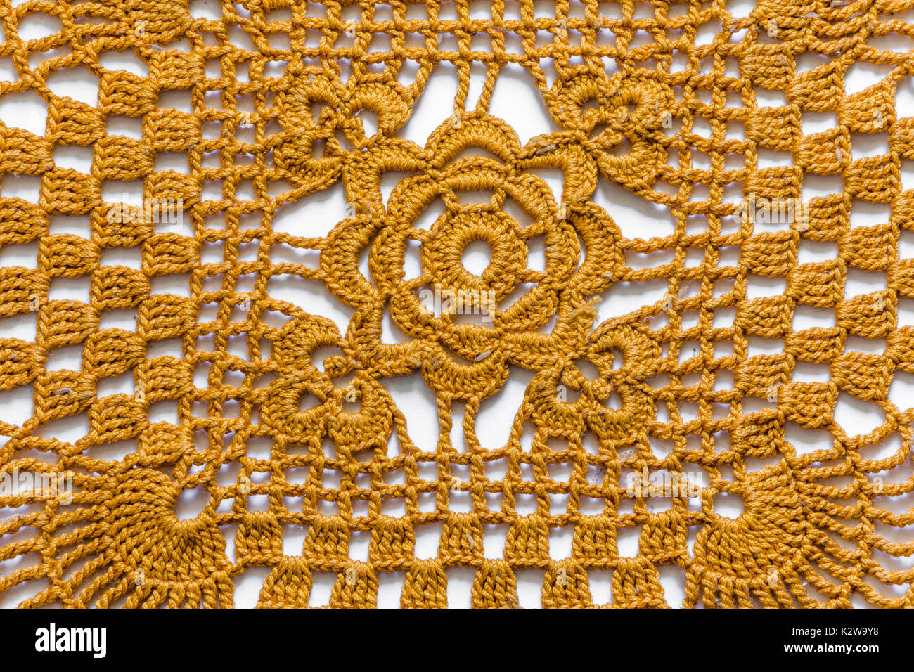 Yellow handmade lace tablecloth texture on white background Stock Photo ...