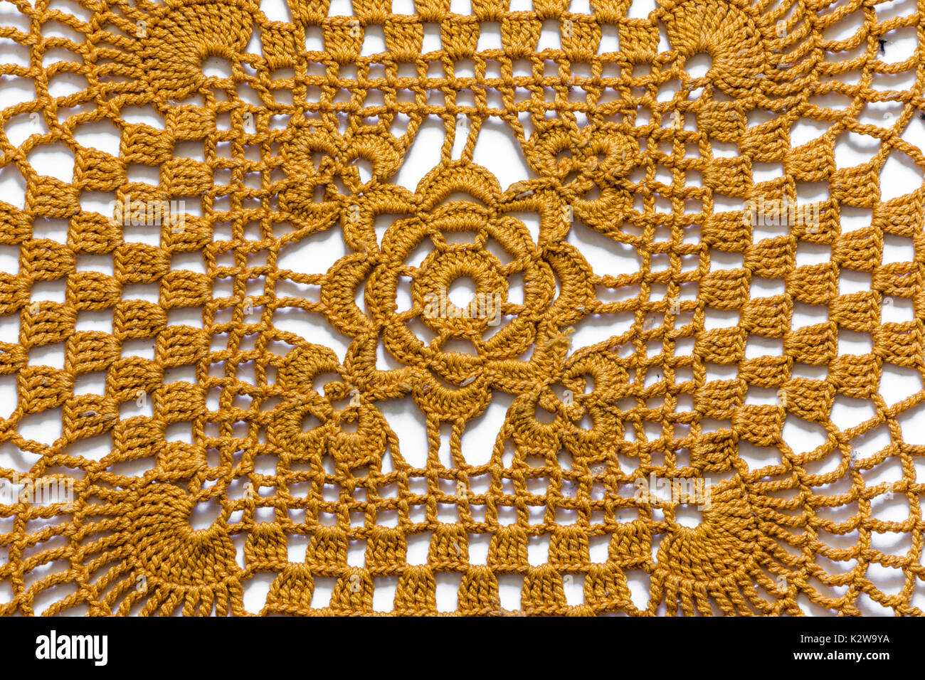 Yellow handmade lace tablecloth texture on white background Stock Photo ...