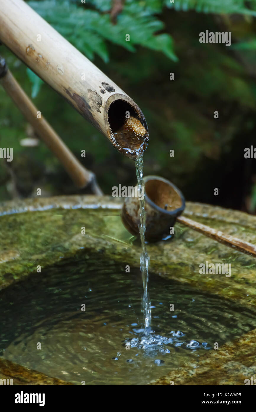 Bamboo Pipe with water dipper Stock Photo - Alamy