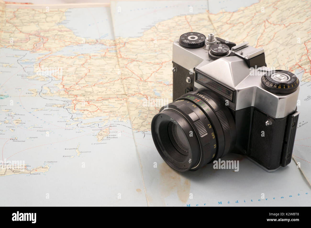 Old film camera on a map Stock Photo - Alamy