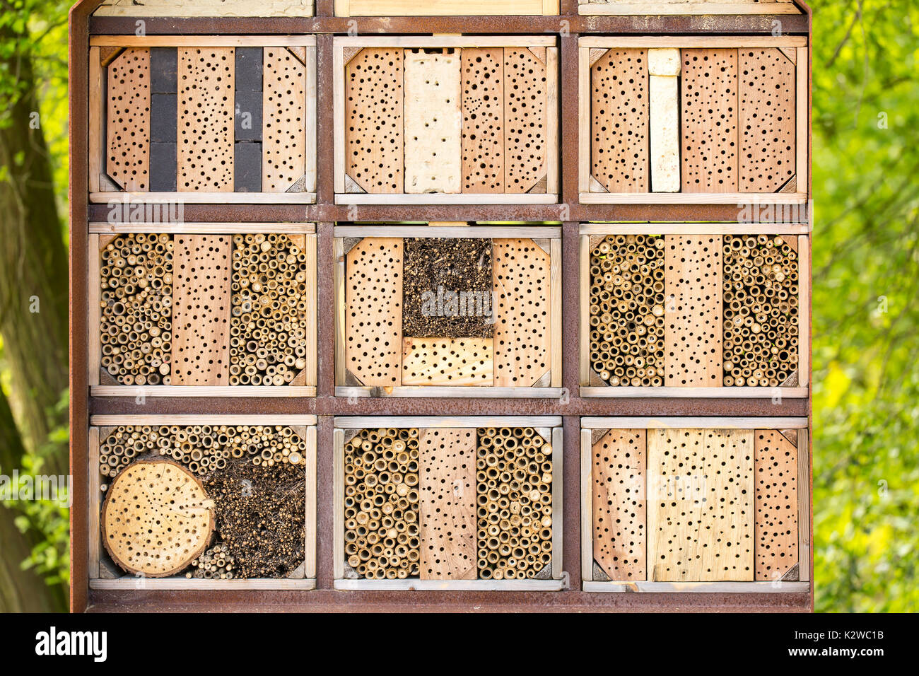 Man-made insect hotel in a green forest. A structure created from ...