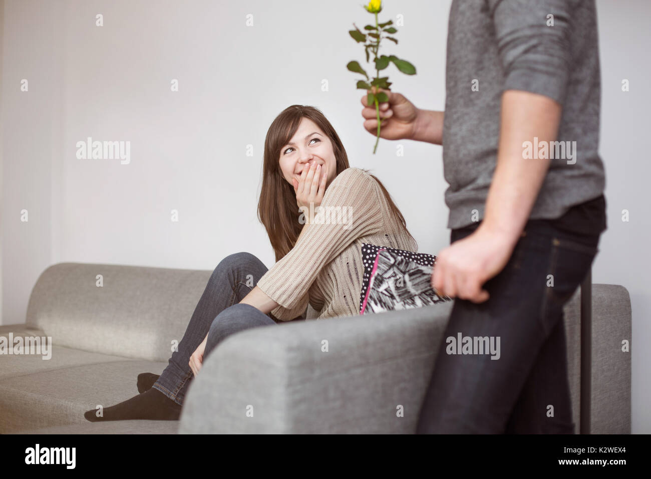 Surprised woman receiving a flower on women's day Stock Photo - Alamy