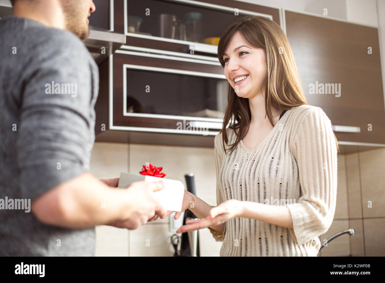 Housewife receiving a present from her husband Stock Photo - Alamy