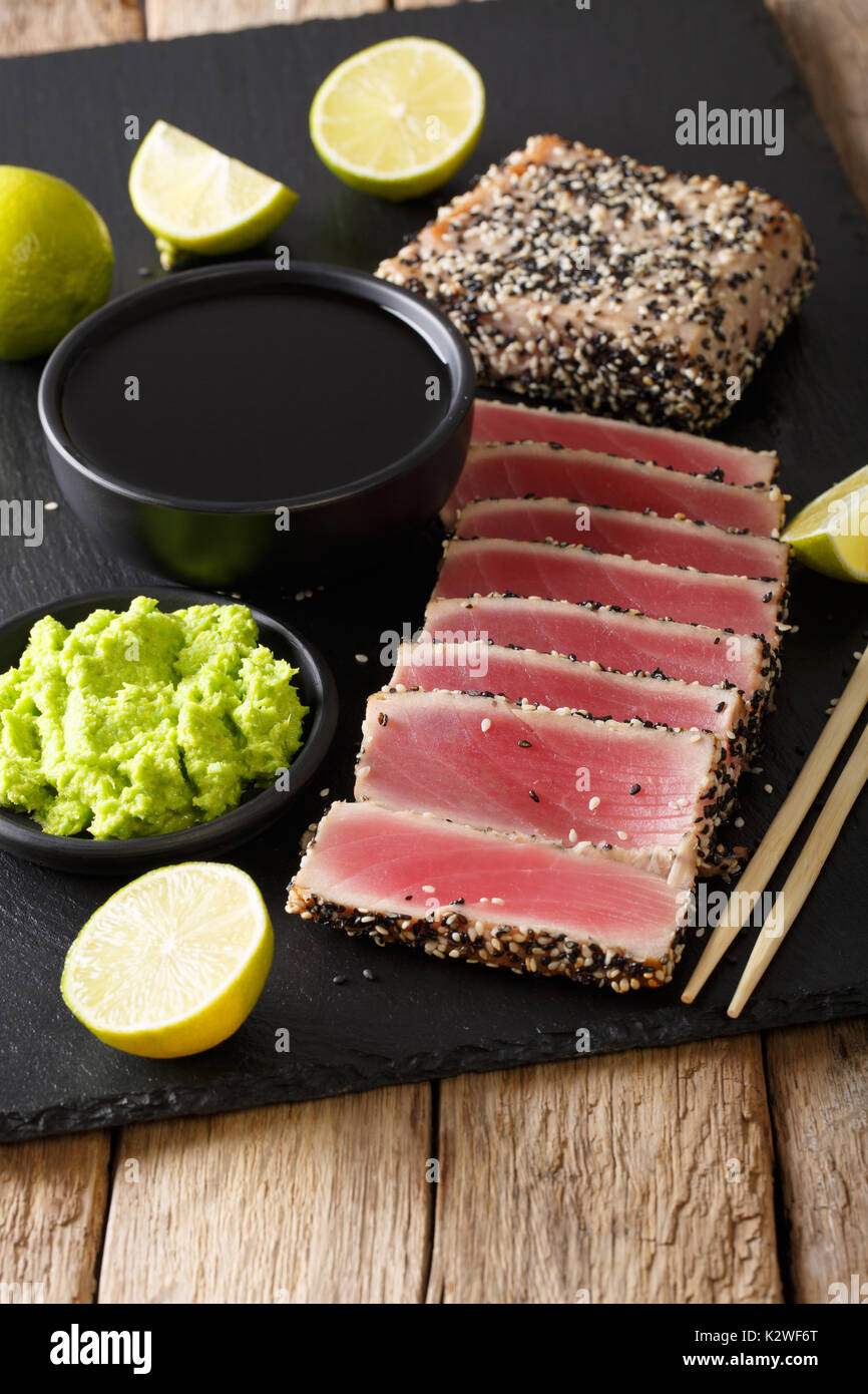 Healthy food: tuna steak in sesame and soy sauce, wasabi, lime closeup ...