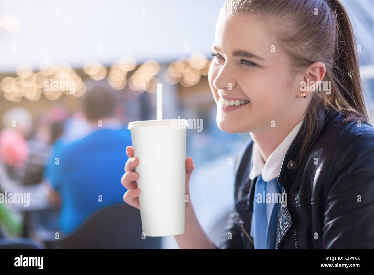 Woman in fast food restaurant drinking coke Stock Photo - Alamy