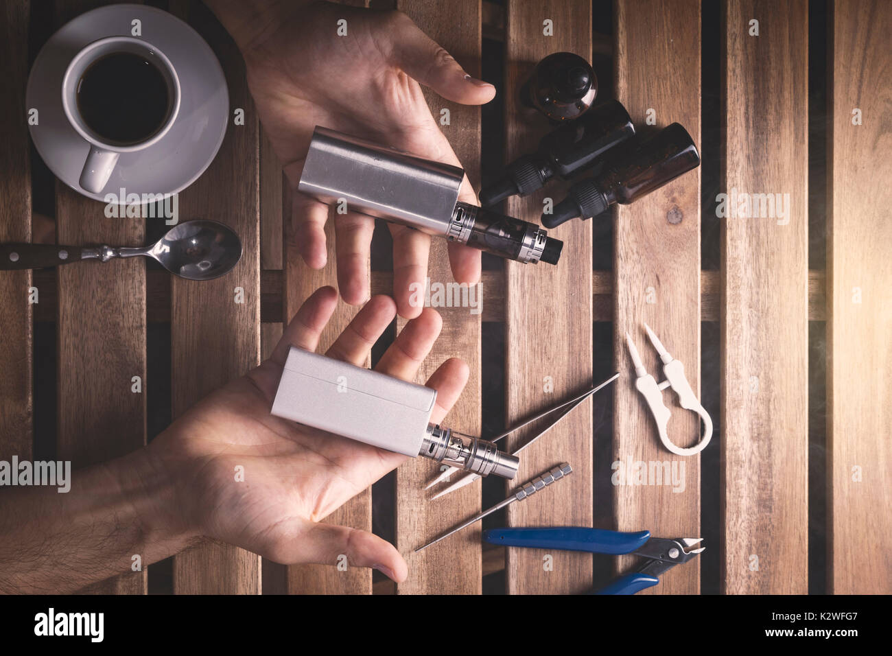 user holding by hands an electronic cigarette, vaping device top view ...