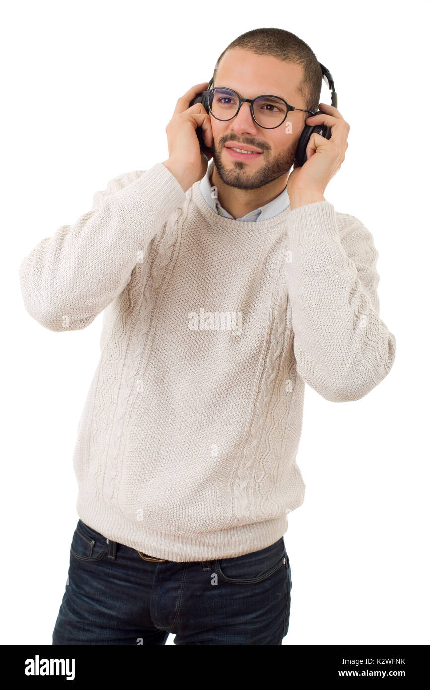 Casual young man listening music with headphones, isolated on white ...