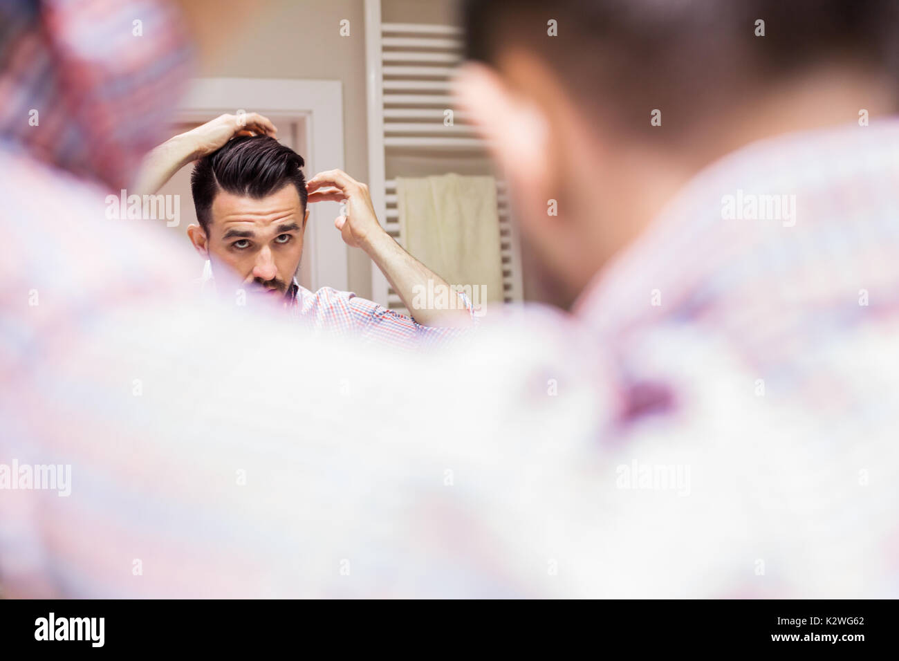Man doing hair in mirror hi-res stock photography and images - Alamy
