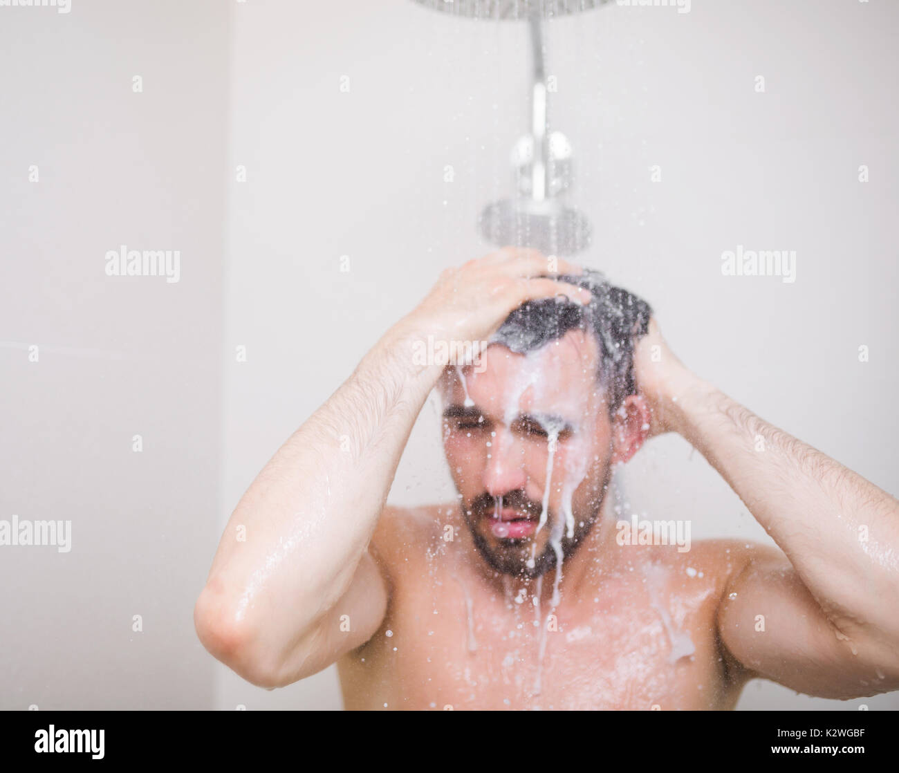 Man washing hair at the shower Stock Photo - Alamy