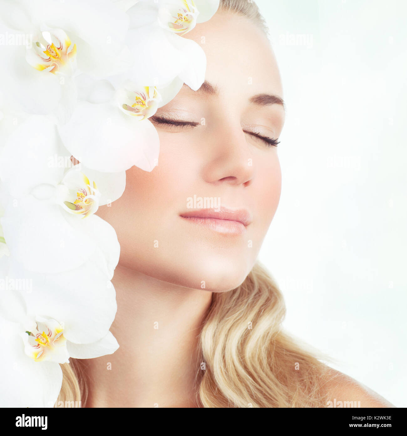 Closeup portrait of a gentle female with closed eyes, many white tender ...