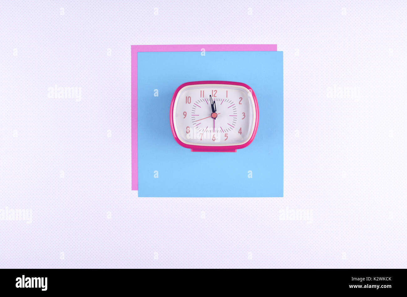 Pink clock on colorful background. Concept of Time. Flat lay style with ...