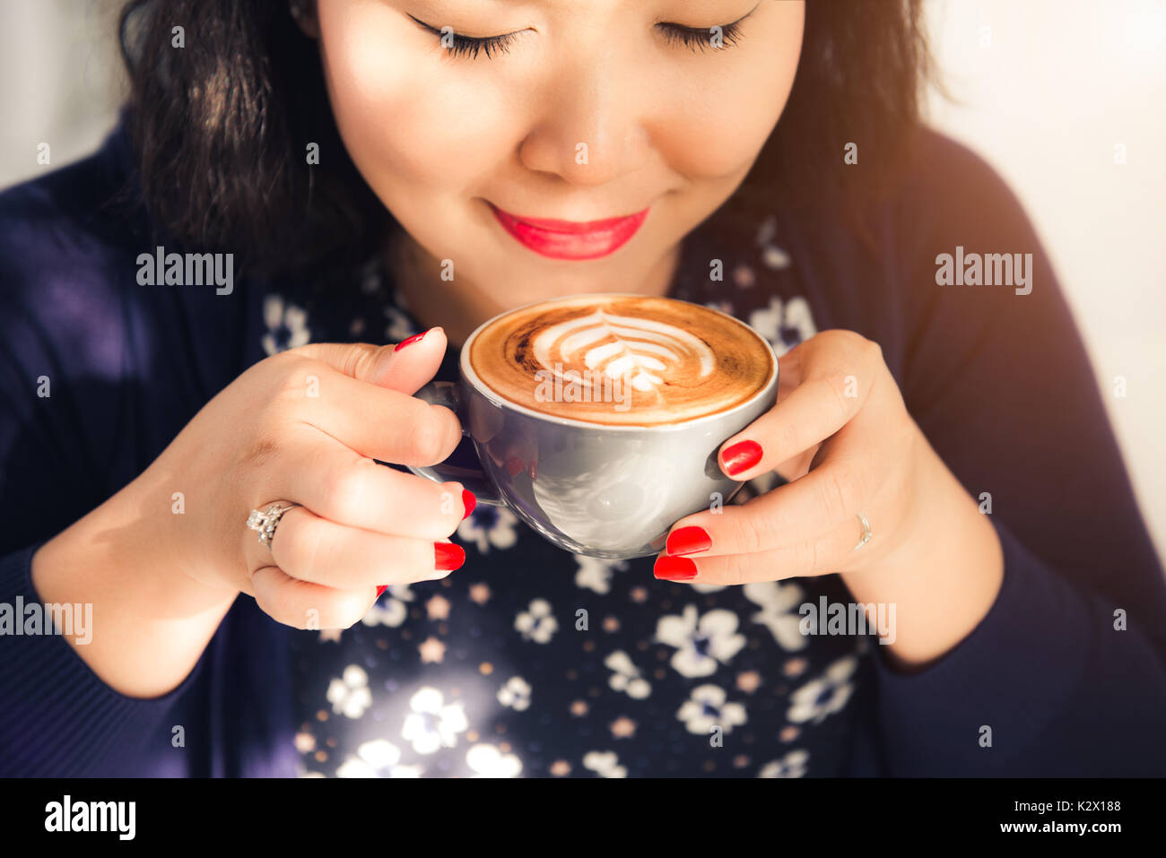 Asian young woman enjoy latte coffee cup Stock Photo - Alamy
