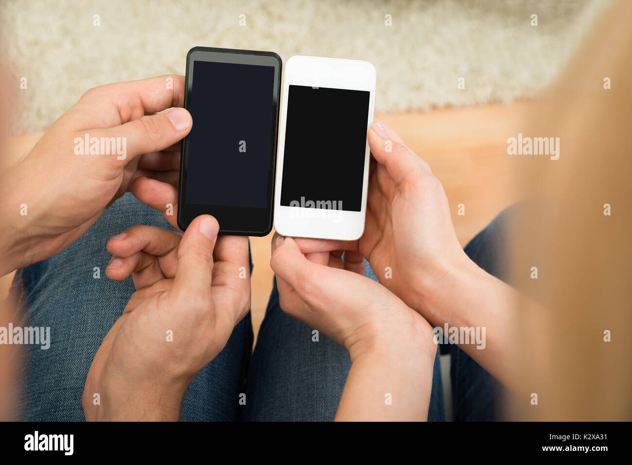 High Angle View Of Two People Holding Mobile Phones Stock Photo - Alamy
