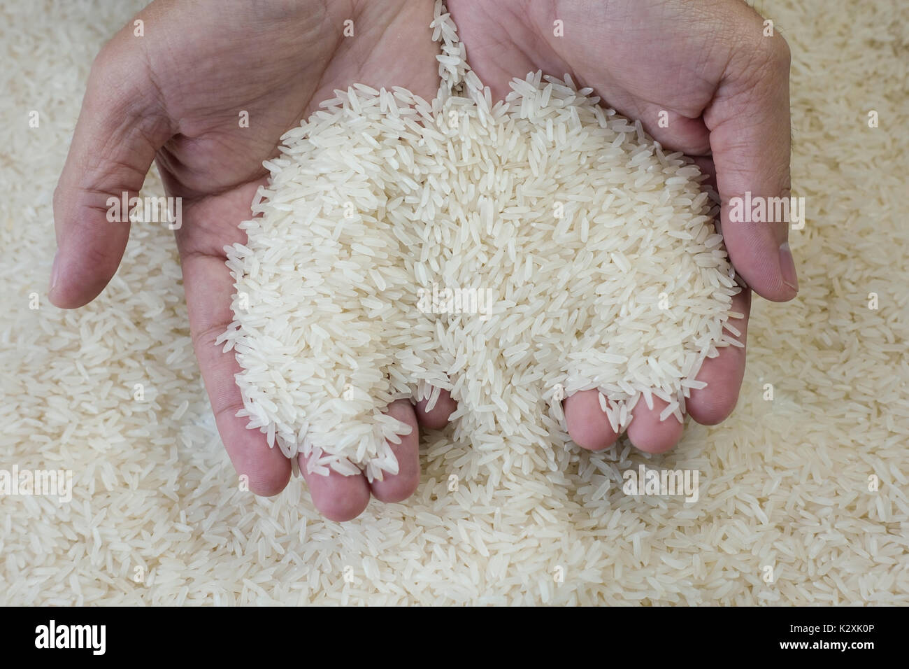 Two hands holding rice - closeup Stock Photo - Alamy
