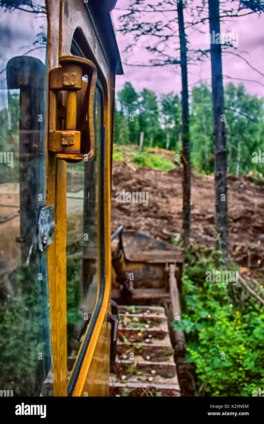 Destruction of forests for construction. Bulldozer clears site for ...