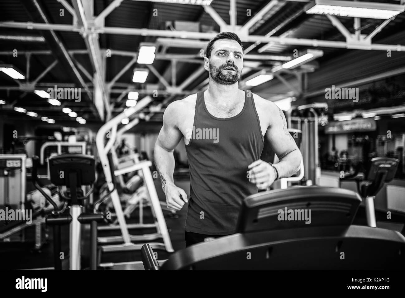 Muscle man running on treadmill Stock Photo - Alamy