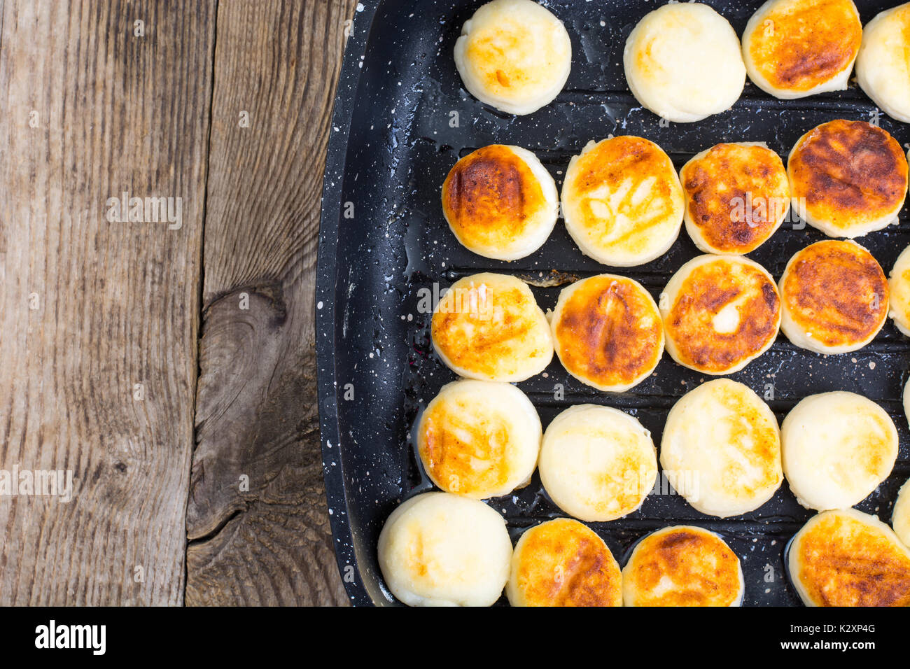 Sweet little fried cheesecakes in frying pan. Studio Photo Stock Photo ...