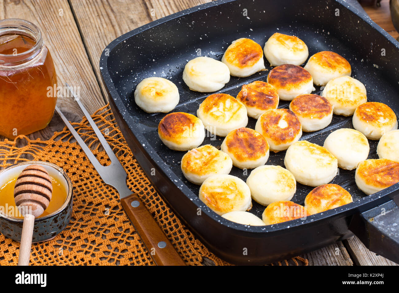 Sweet little fried cheesecakes in frying pan. Studio Photo Stock Photo ...
