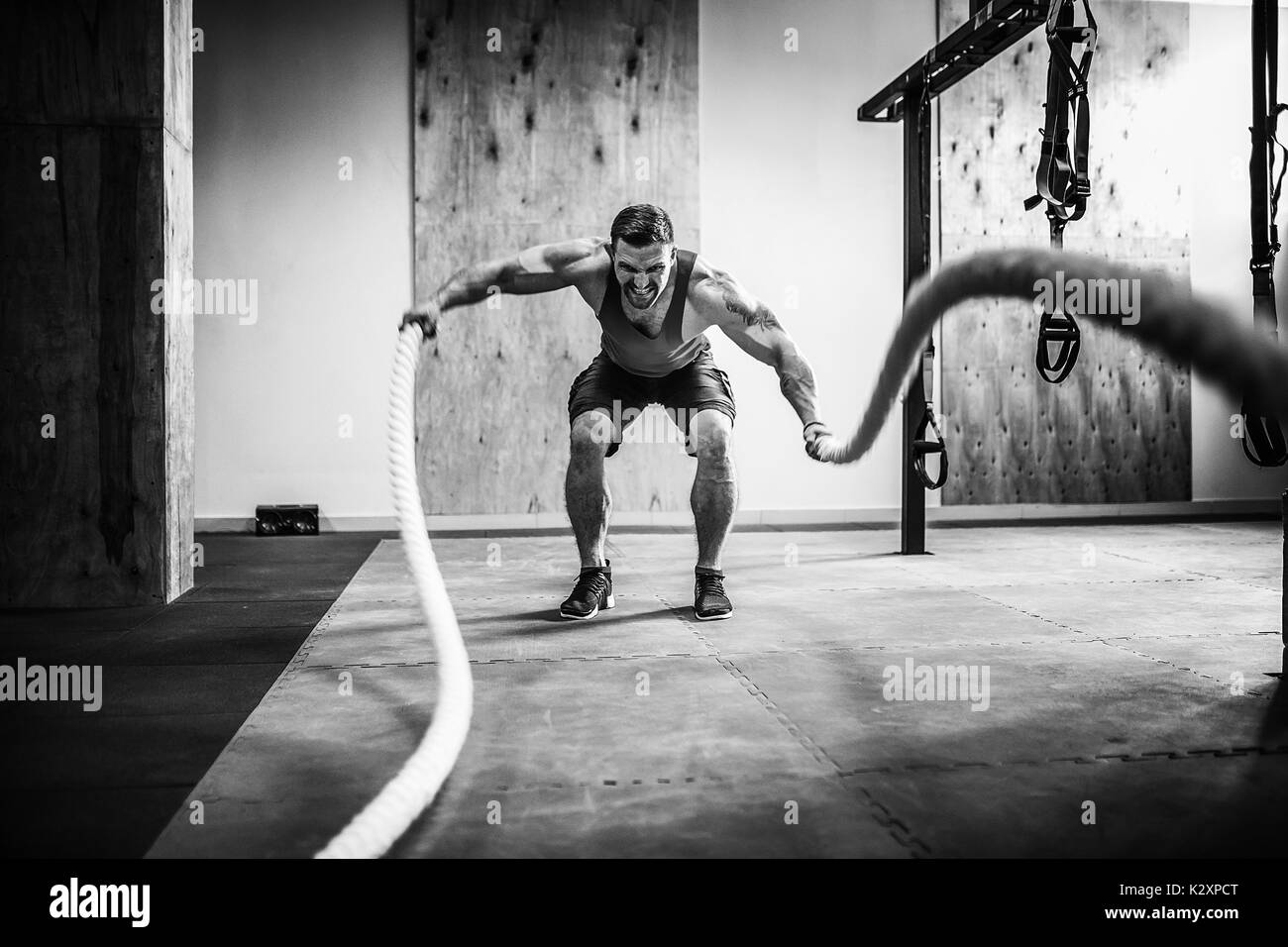 Men with rope in functional training fitness Stock Photo - Alamy