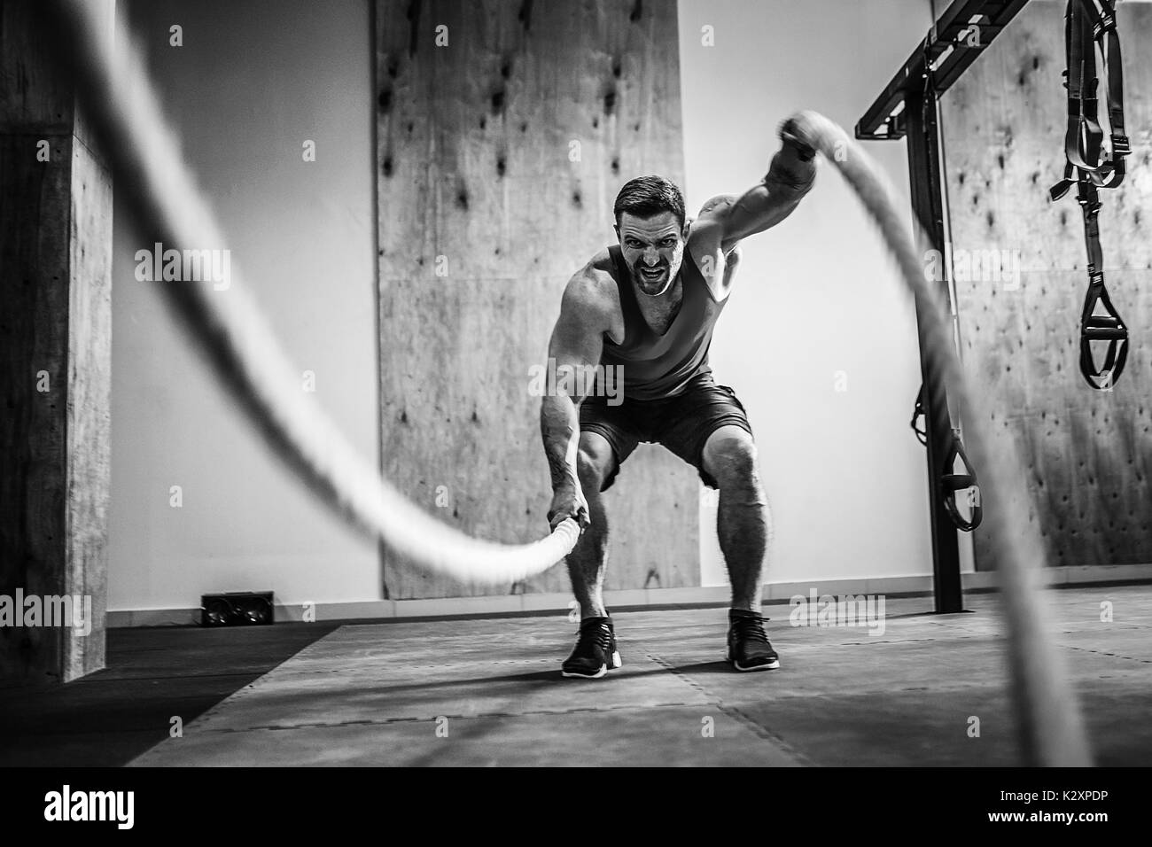 Men with rope in functional training fitness Stock Photo - Alamy