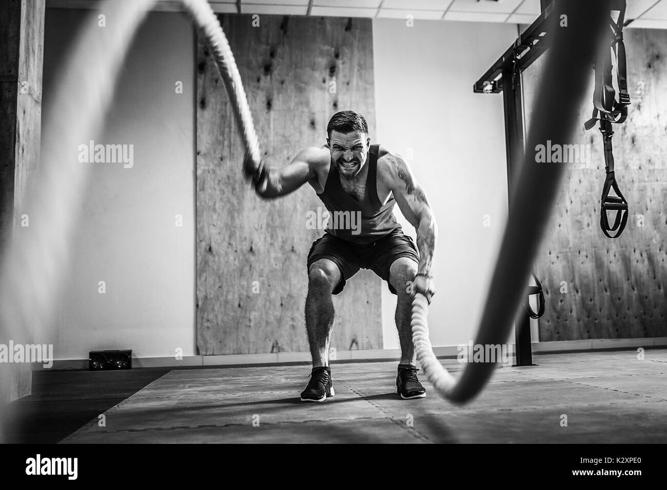 Men with rope in functional training fitness Stock Photo - Alamy