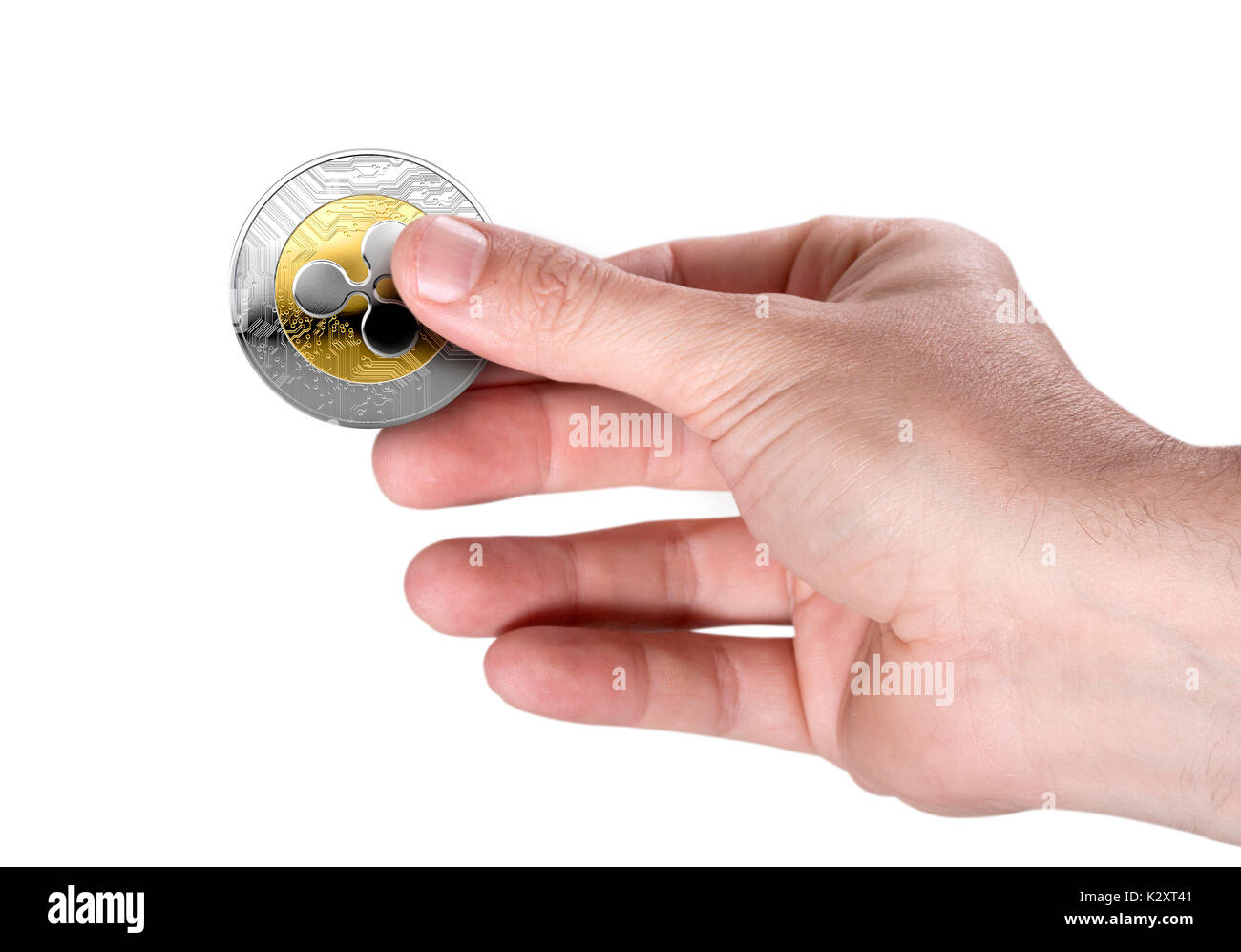 A male hand holding a physical ripple cryptocurrency in gold and silver ...