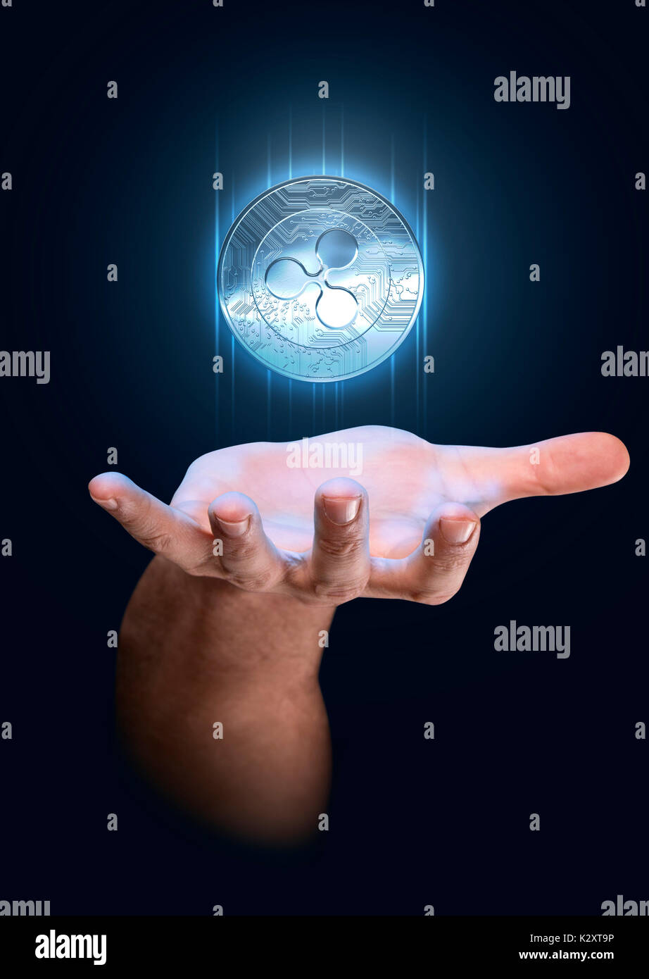 A male hand conjuring up a floating blue ripple cryptocurrency hologram ...