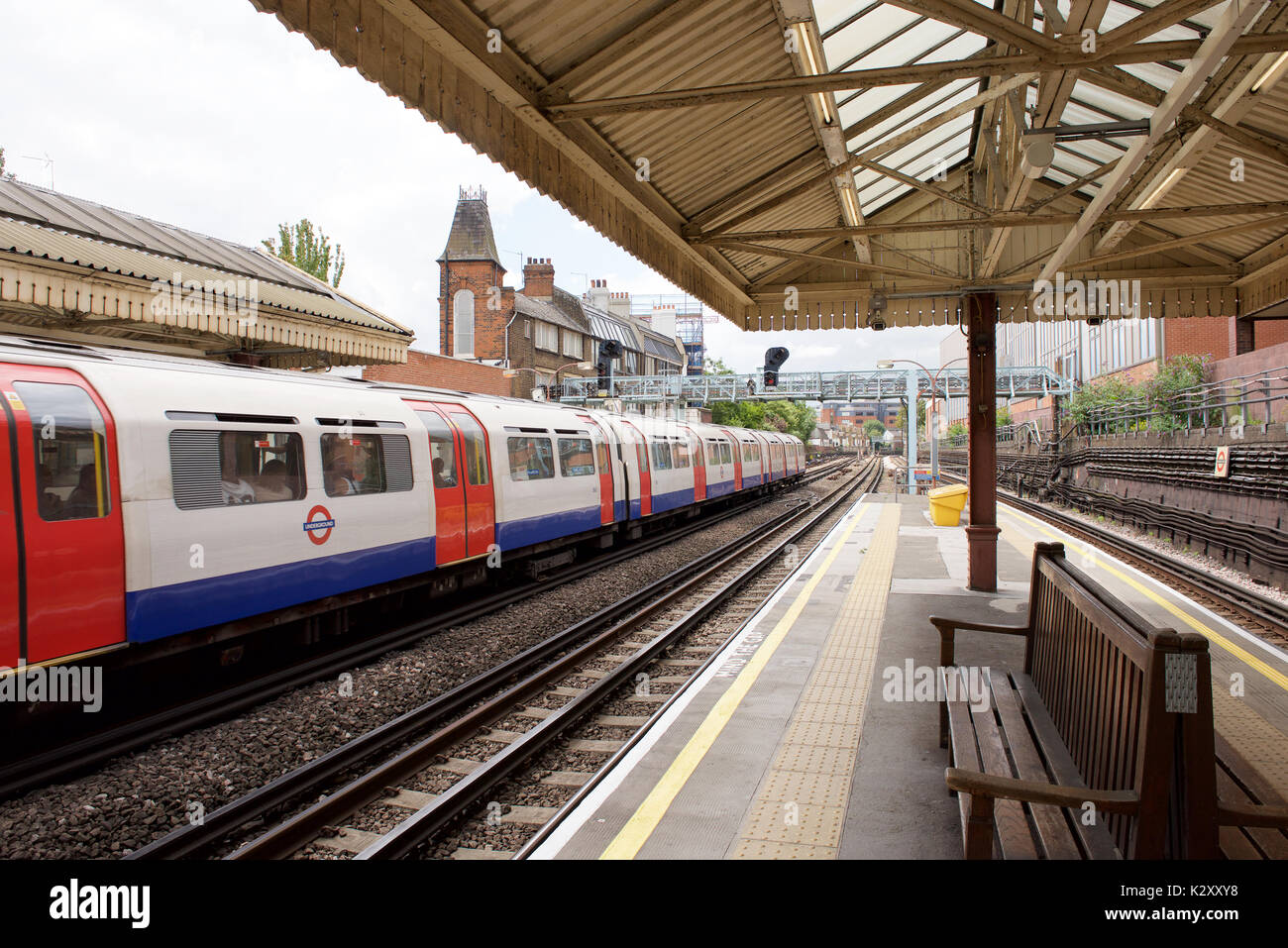 Underground train at Barons Court Underground station in London Stock ...