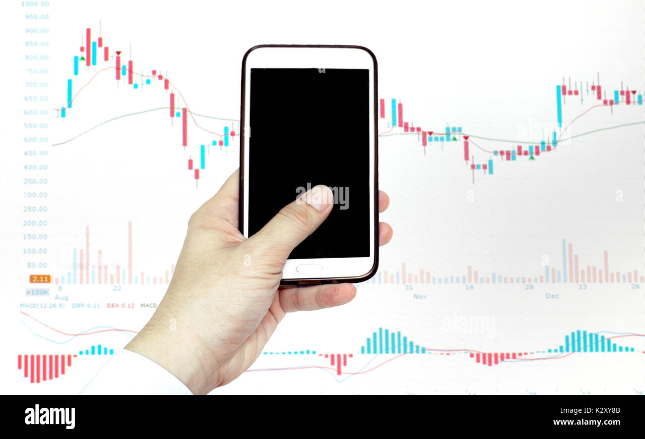 hand holding smartphone with stock exchange screen Stock Photo - Alamy