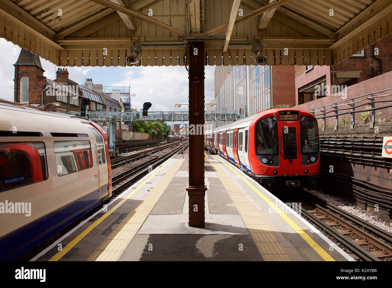Underground train at Barons Court Underground station in London Stock ...