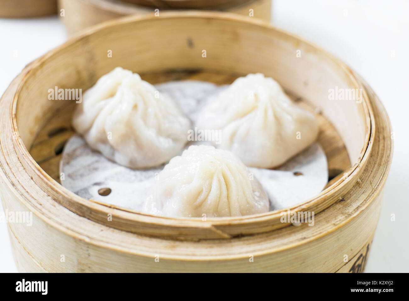 Chinese dumplings inside of bamboo steamer Stock Photo - Alamy