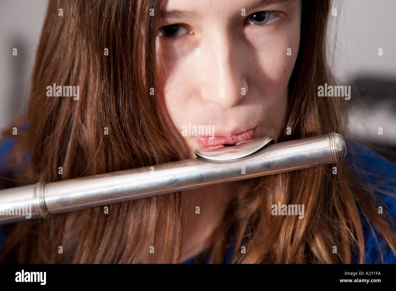 Portrait of young girl playing a flute Stock Photo - Alamy