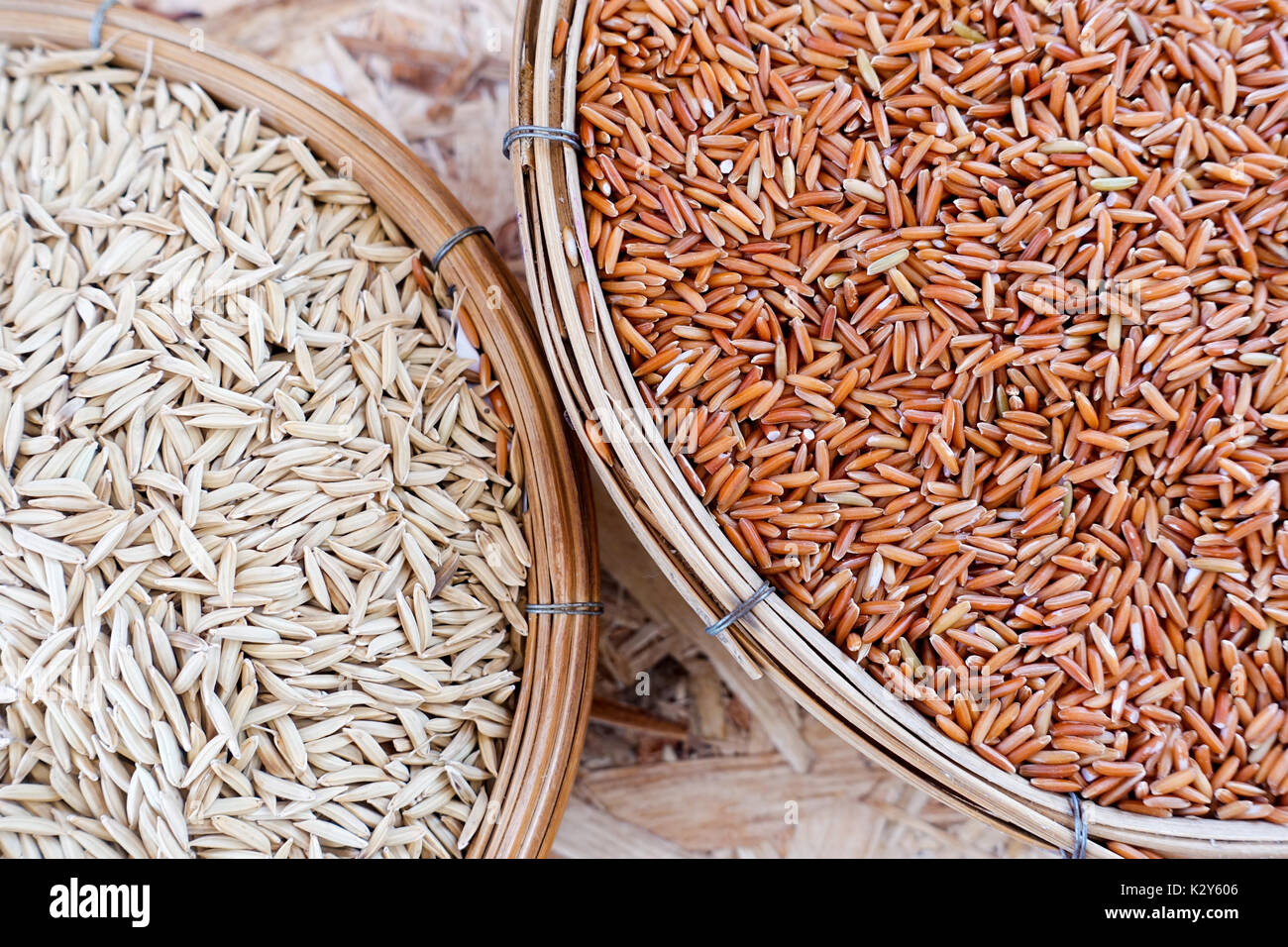 Red rice grains and paddy rice in bamboo basket - closeup Stock Photo ...