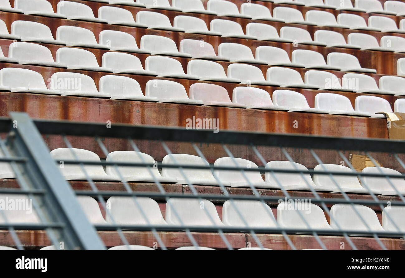 Robust metal mesh in the stadium to divide the fans on the stairs from ...