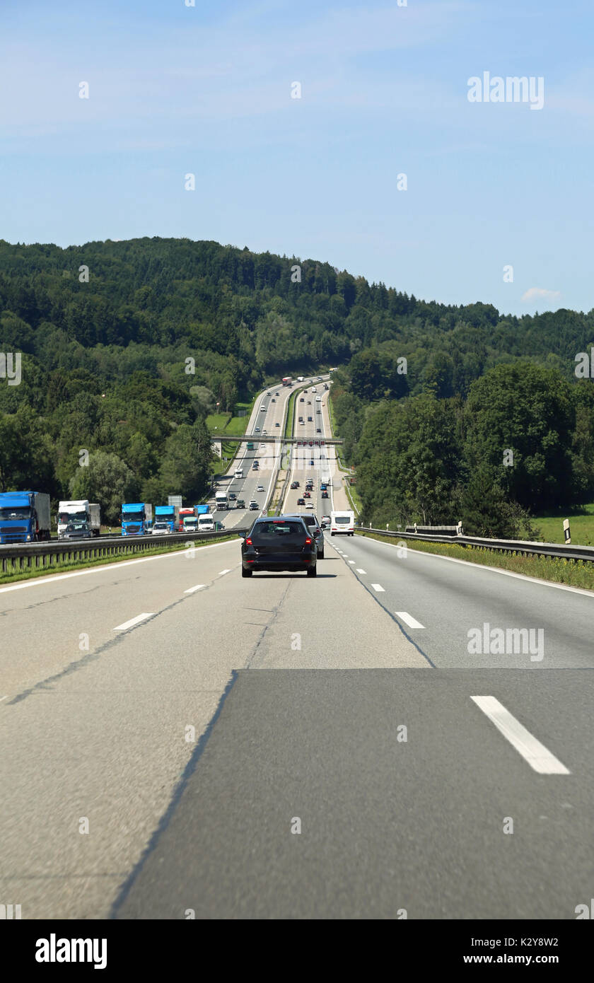 Very long highway with three lanes for every direction of traffic with ...