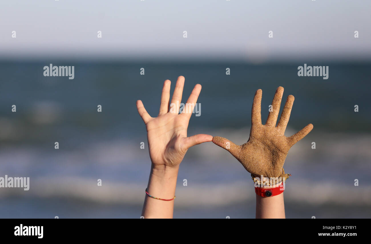 Greetings with the two hands of the child with ten fingers Stock Photo ...