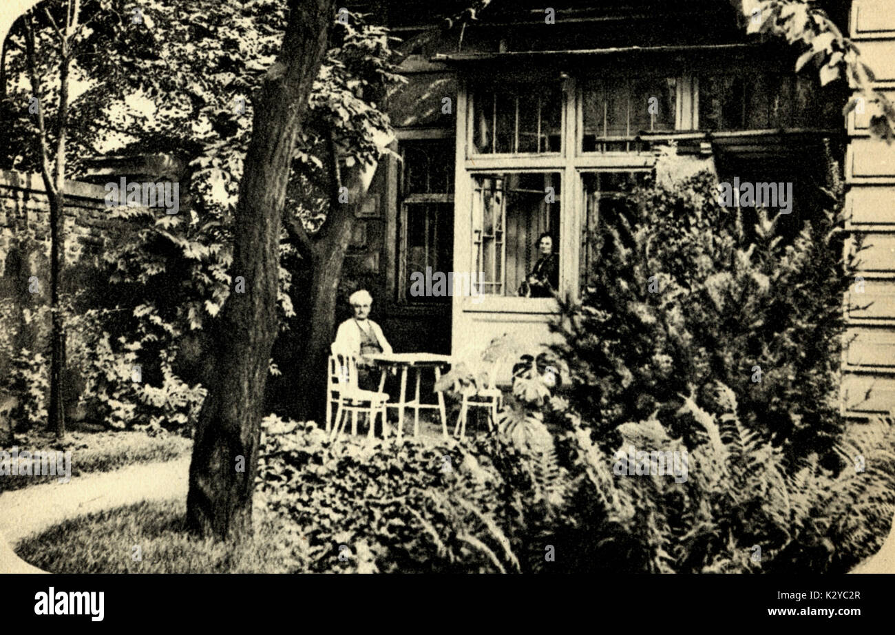 Leos Janacek seated in front of home in garden Brno. Wife Zdenka at ...