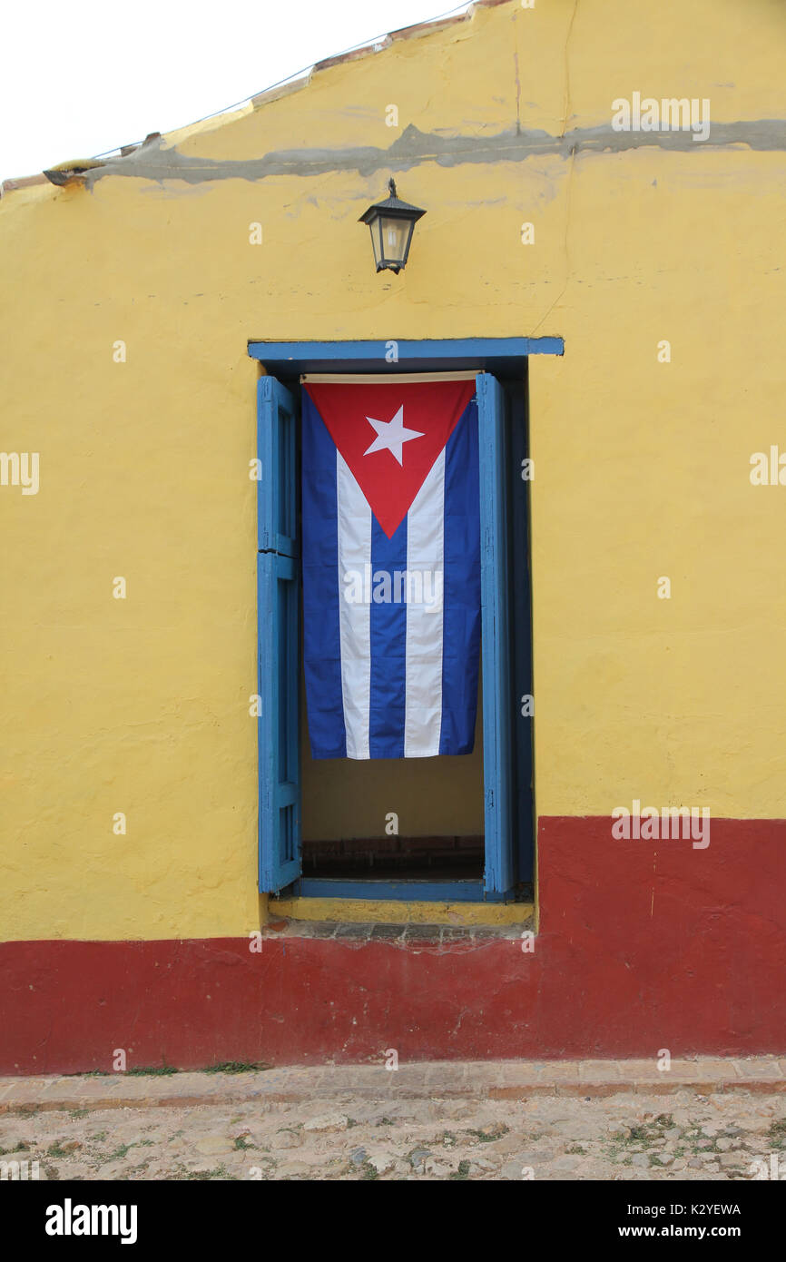 Cuban flag hanging in a Trinidad window Stock Photo - Alamy