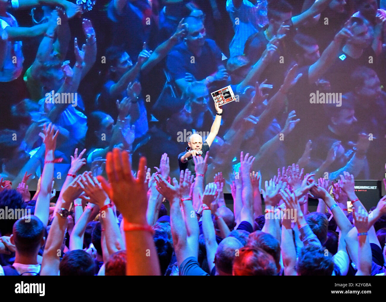 Presenter distributes free computer games to cheering crowd of young ...