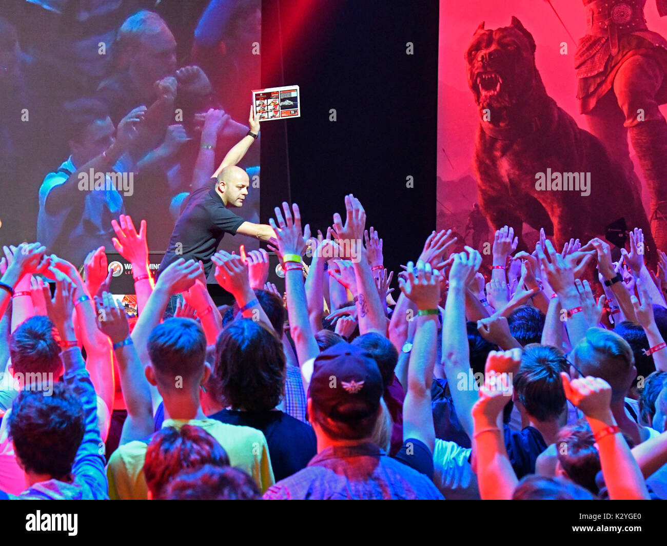 Presenter distributes free computer games to cheering crowd of young ...