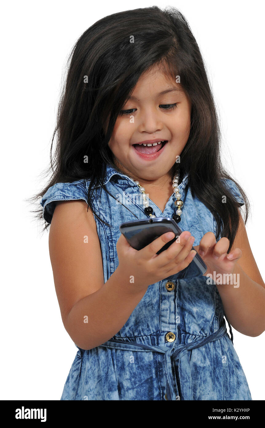 Beautiful little girl texting on a cell phone Stock Photo - Alamy