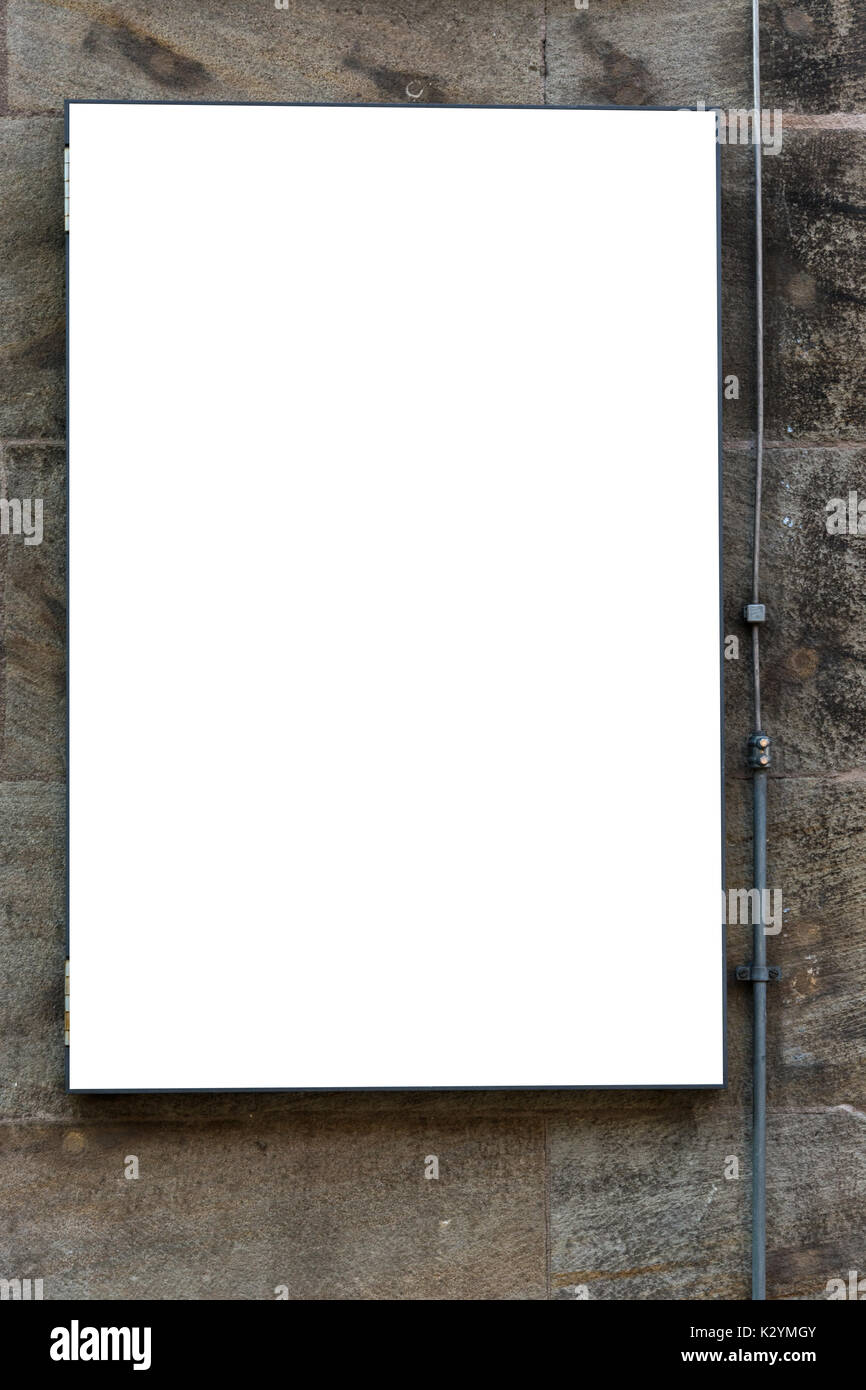 Blank ad space sign isolated in the street on a wall from the front ...