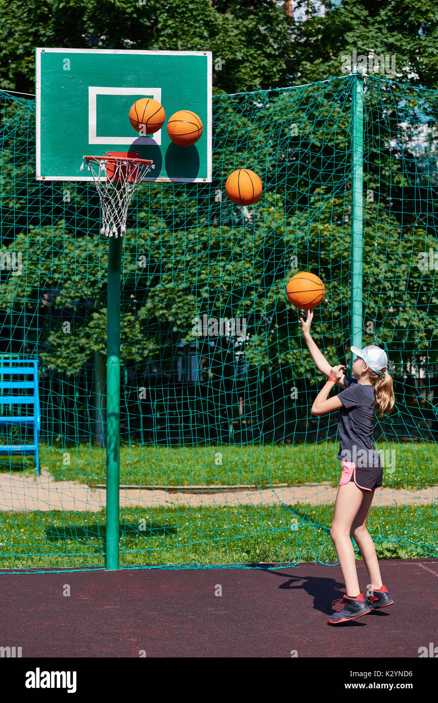 Girl basketball player throws the ball in basket Stock Photo - Alamy